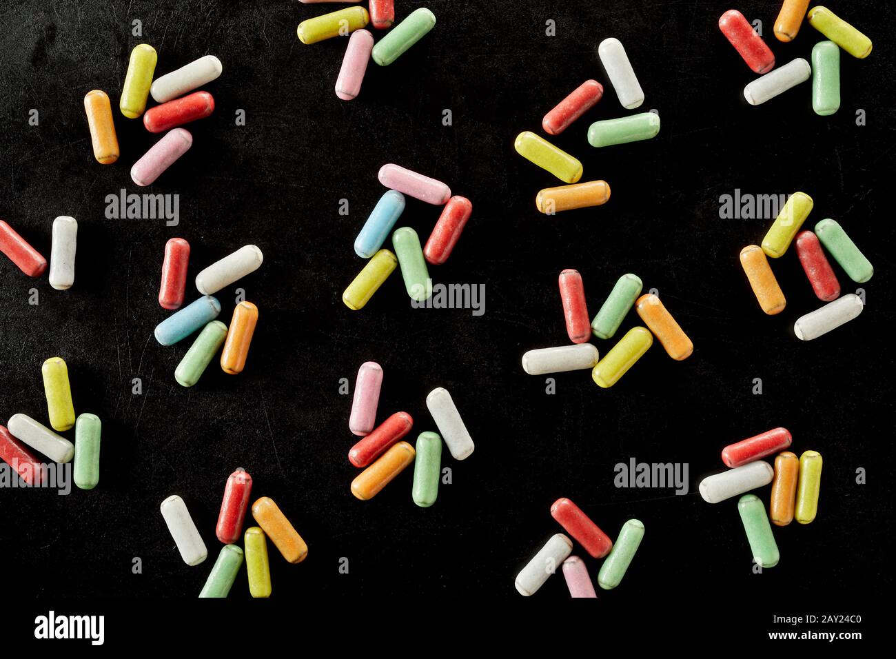 Abstract pattern of repeat groups of colorful sugar-coated liquorice ...