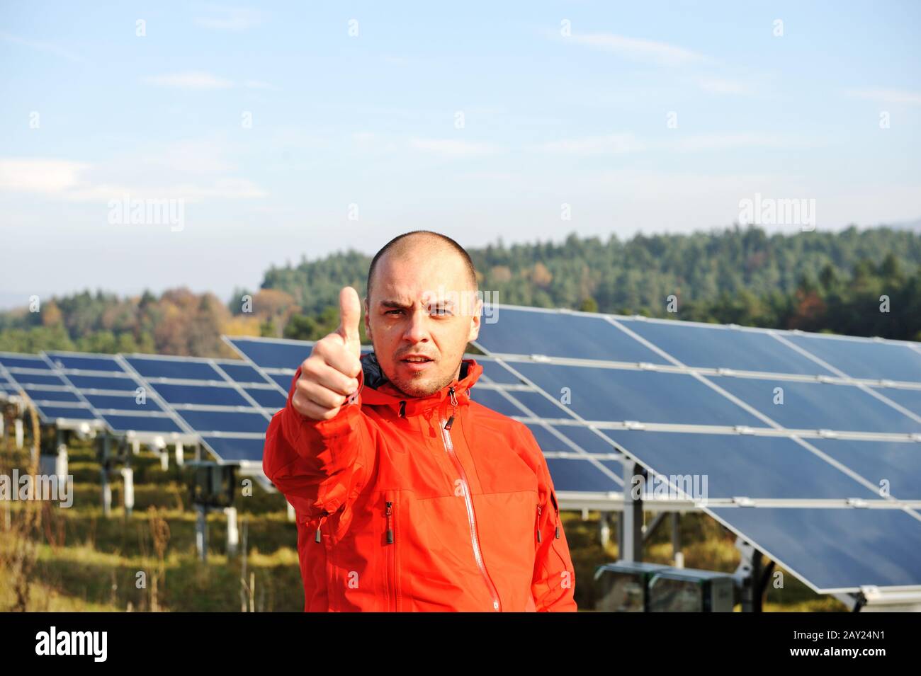 Male worker at solar panel field Stock Photo - Alamy