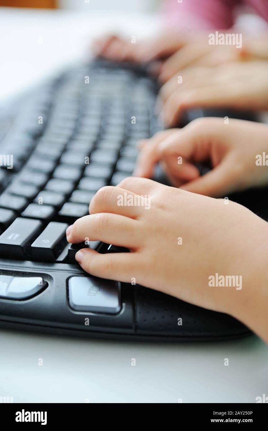 Child hands typing on keyboard Stock Photo - Alamy
