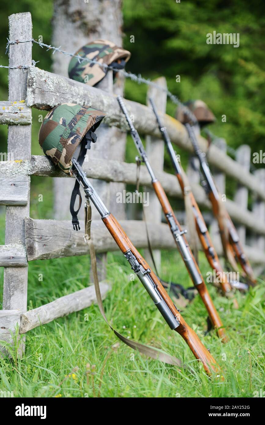 Military rifle and helmet Stock Photo - Alamy