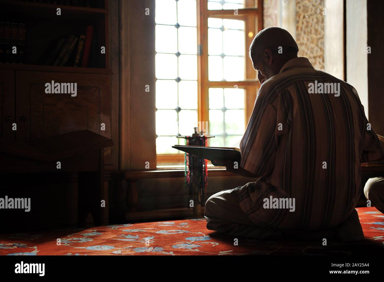 Muslim reading Koran inside mosque Stock Photo - Alamy