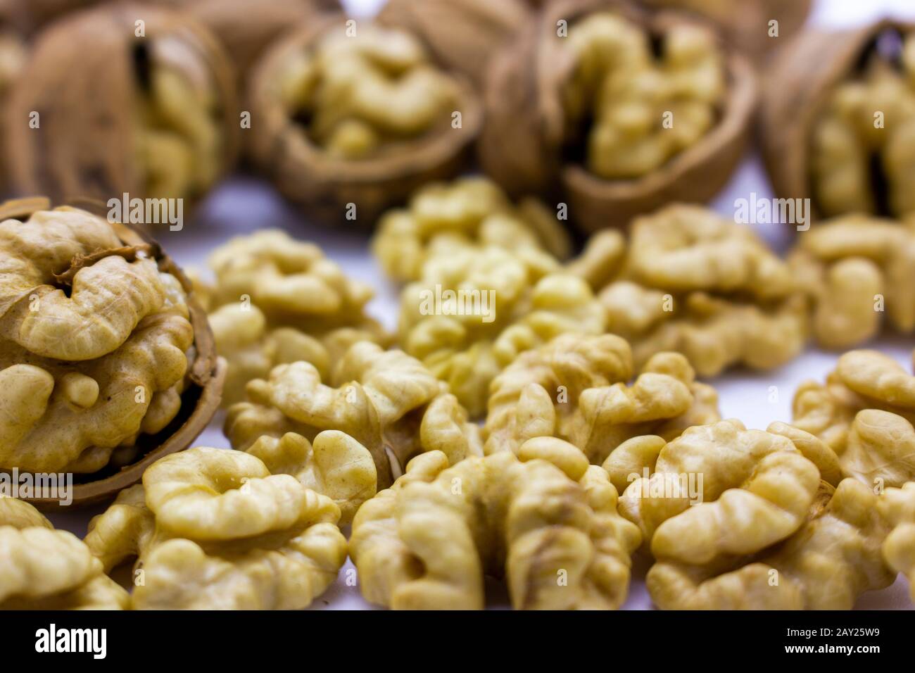 Walnut kernels with peeled nuts on a white background Stock Photo - Alamy