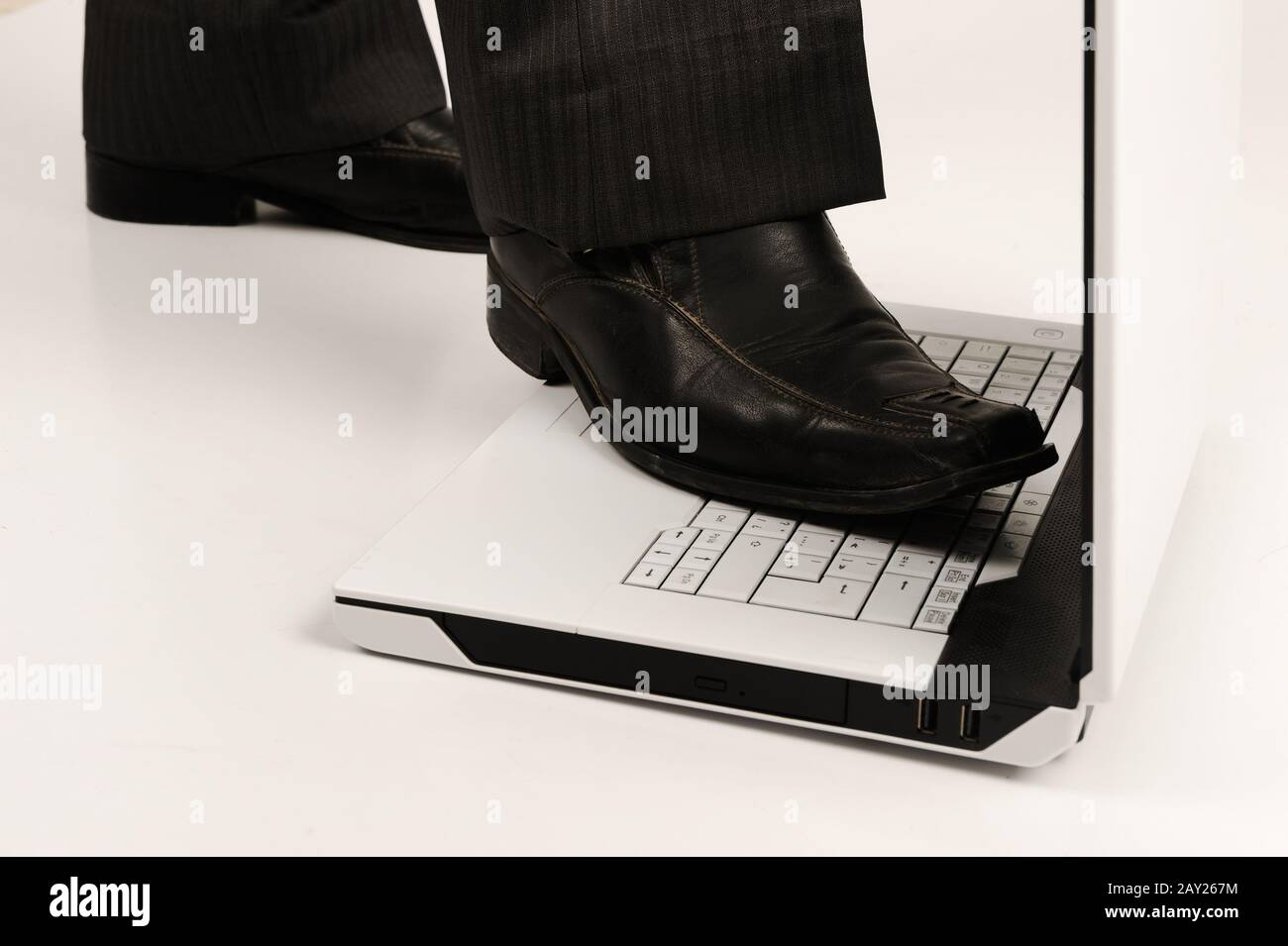 Business foot walk over laptop with white background Stock Photo - Alamy
