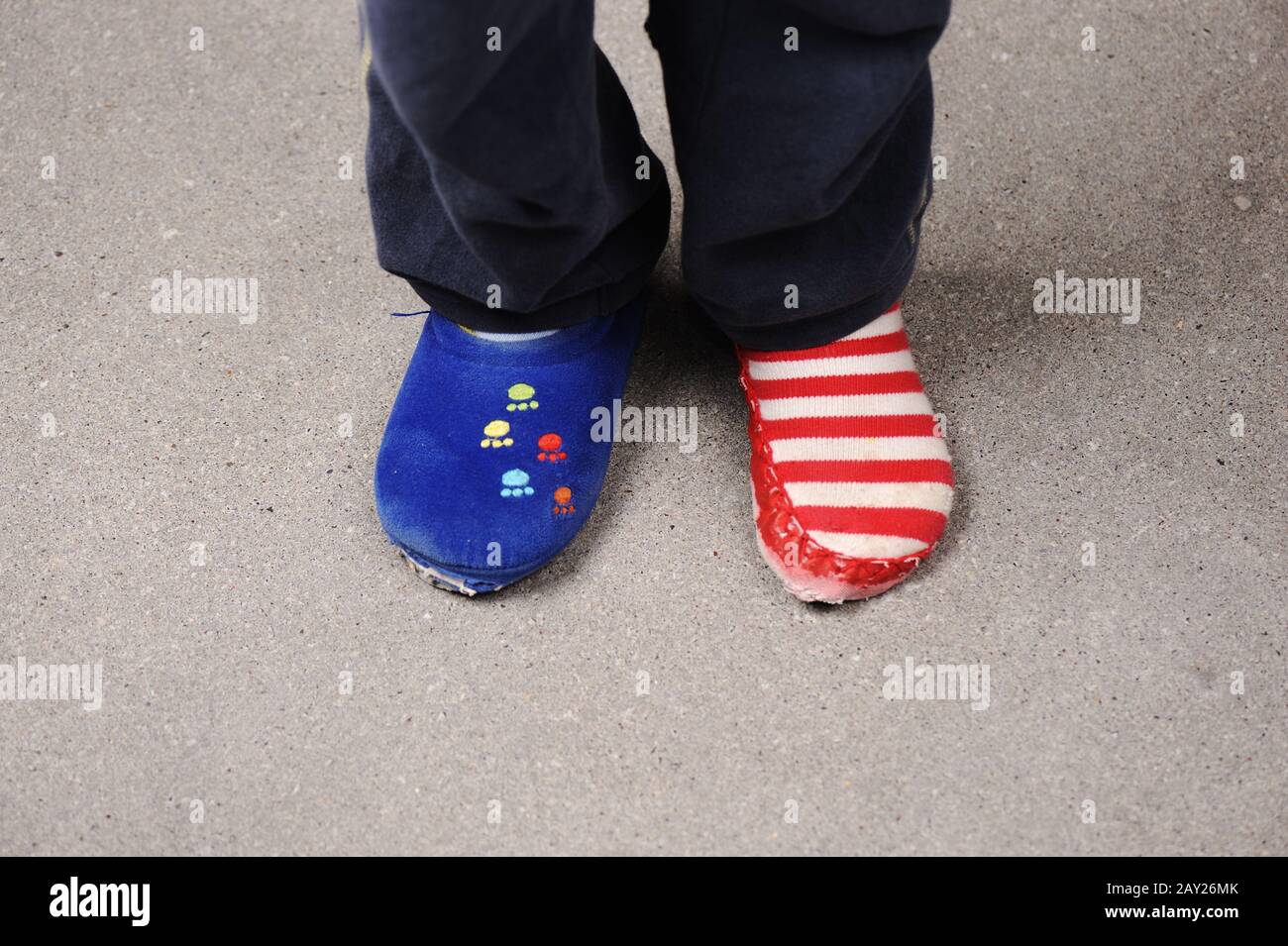 Two different socks on little boy's feet Stock Photo - Alamy