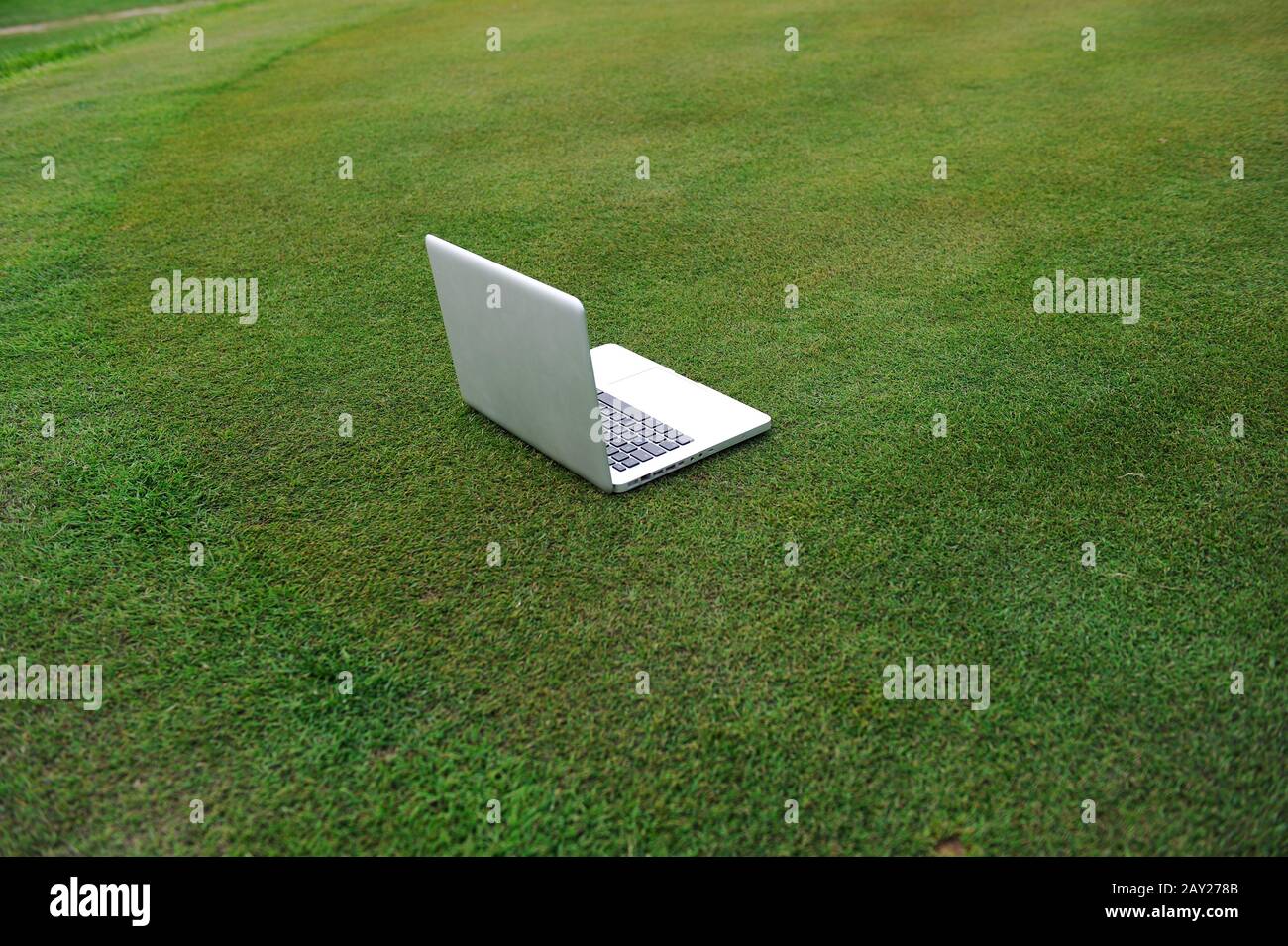 Laptop on grass Stock Photo - Alamy