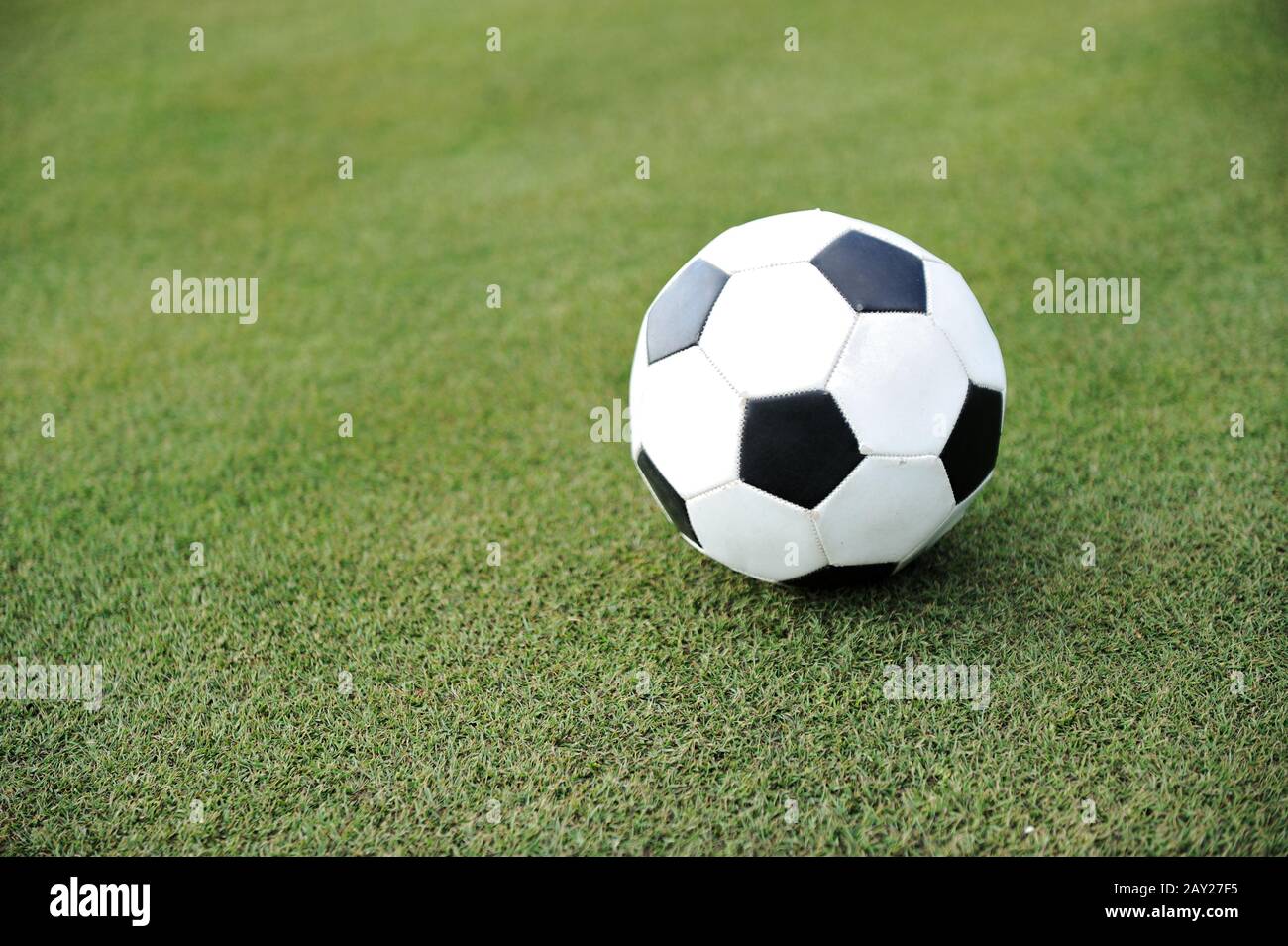 Football on grass field Stock Photo - Alamy