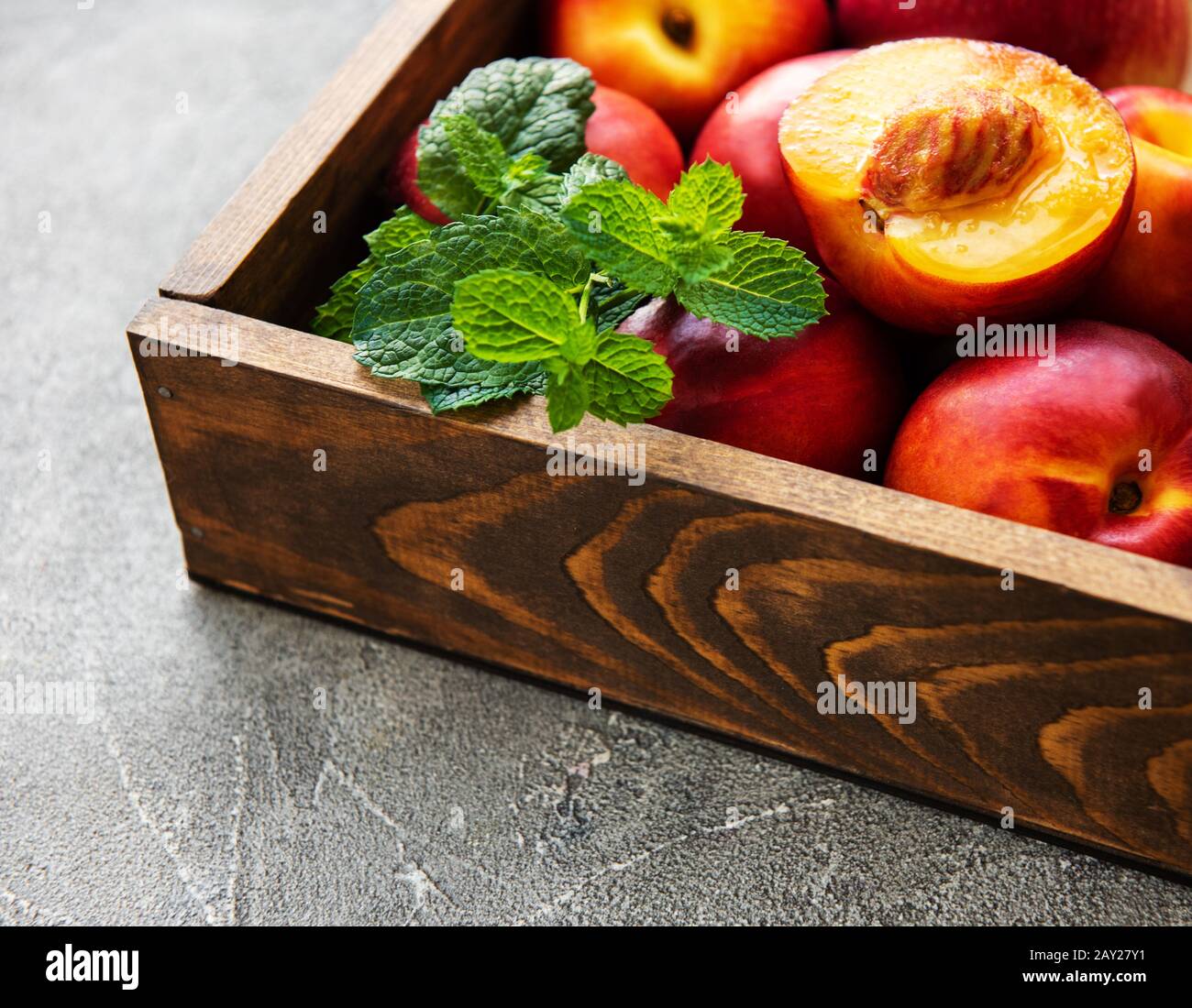 Box with fresh nectarines on a stone background Stock Photo - Alamy