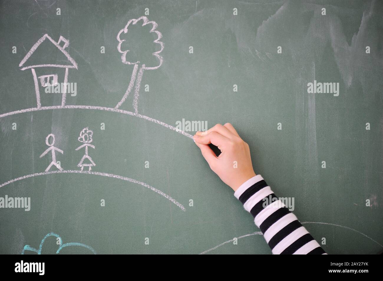 Childs hand drawing on a blackboard Stock Photo - Alamy