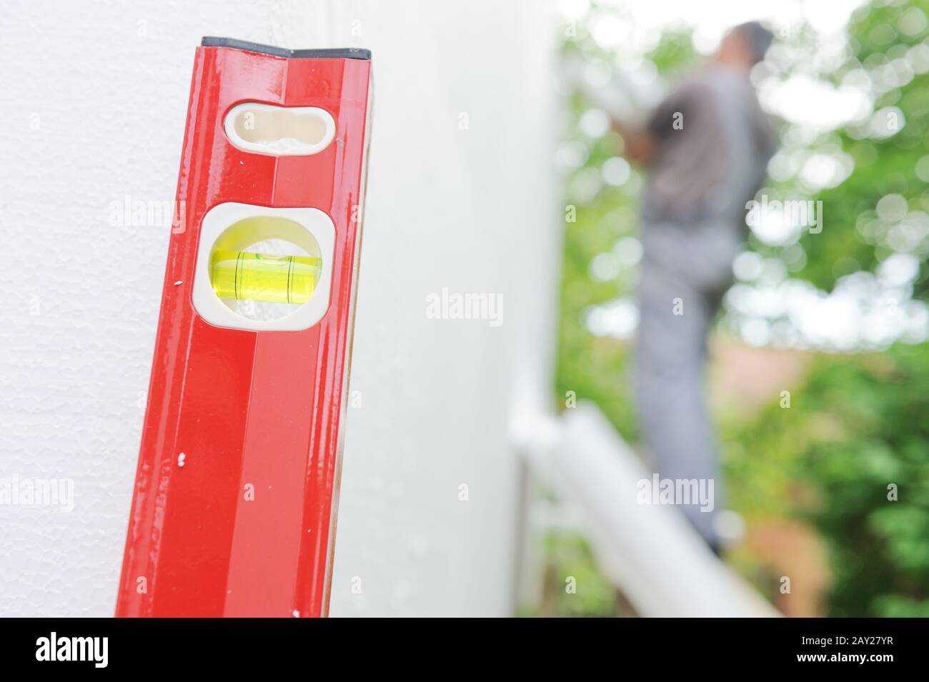 Leveling tool in front of construction worker Stock Photo - Alamy