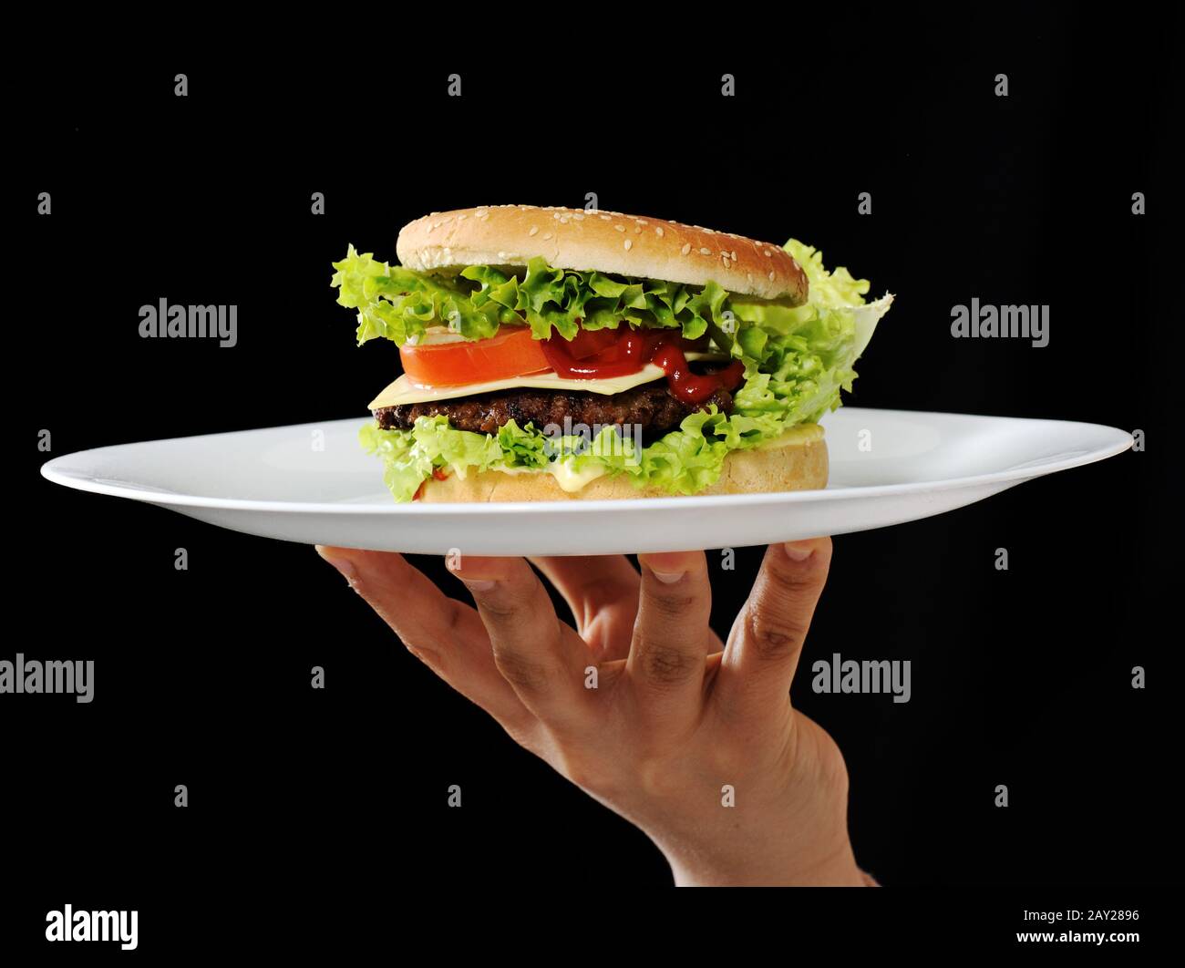 Burger on plate at restaurant Stock Photo - Alamy