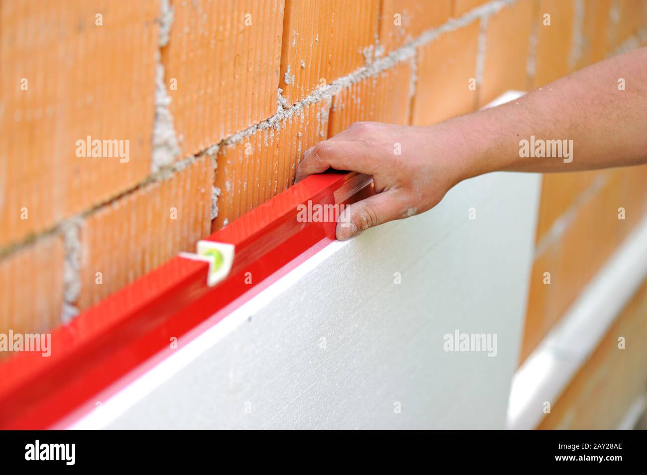 Worker checking horizontal level with leveling tool Stock Photo - Alamy