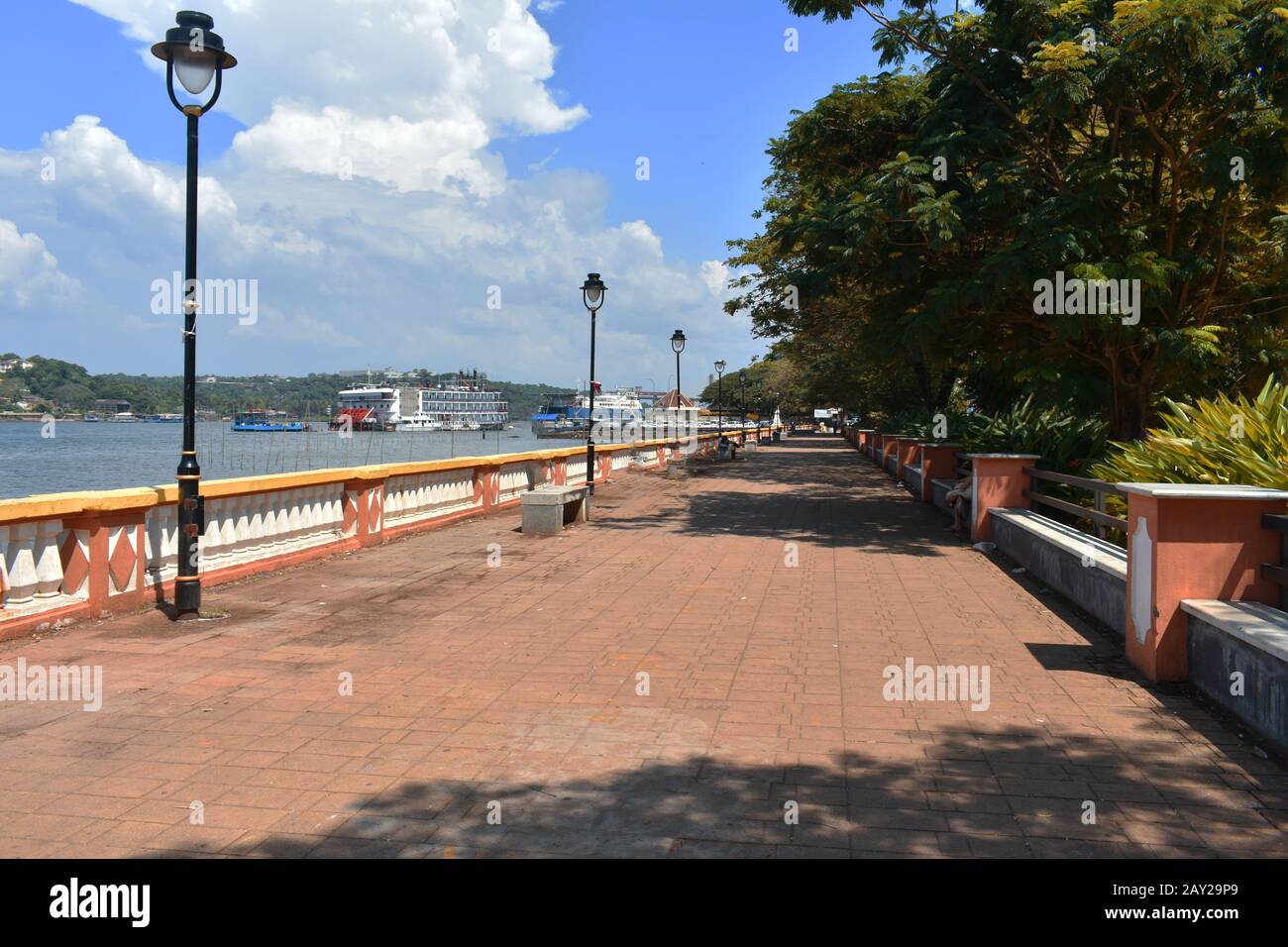 a small walk lane beside river mandovi in Goa with vintage light poles ...
