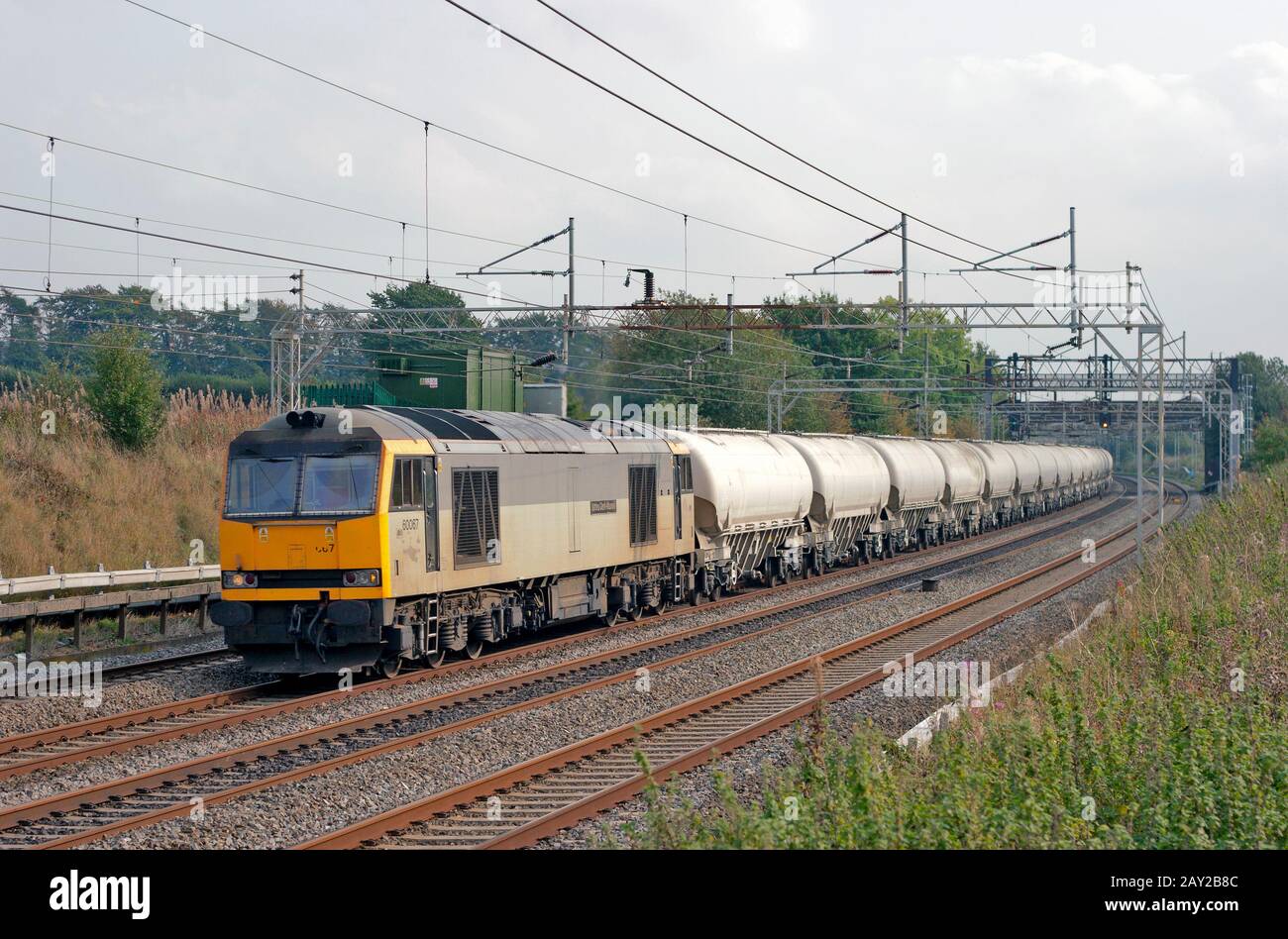 A class 60 diesel locomotive number 60067 working a train of cement ...