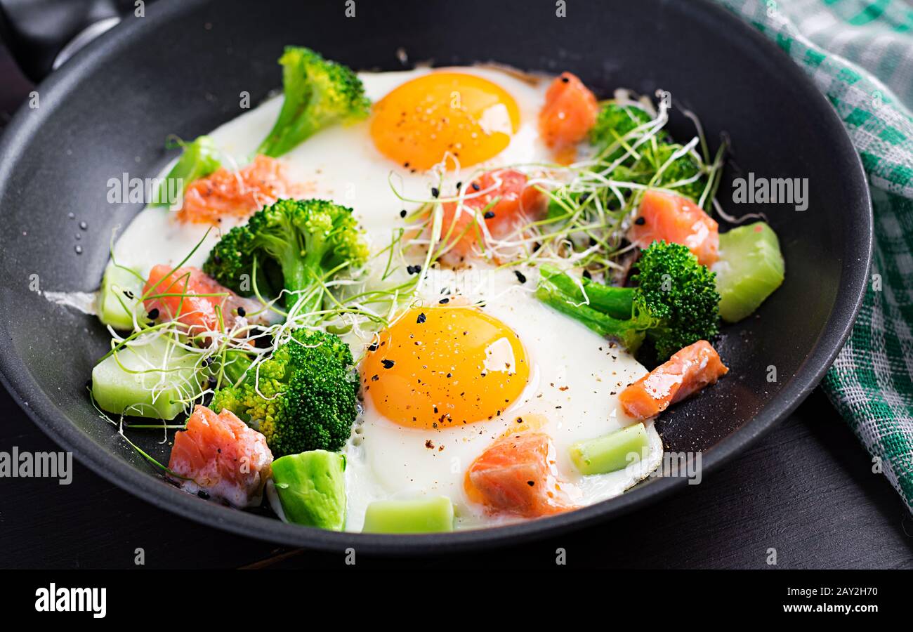 Ketogenic/paleo diet. Fried eggs, salmon, broccoli and microgreen. Keto ...