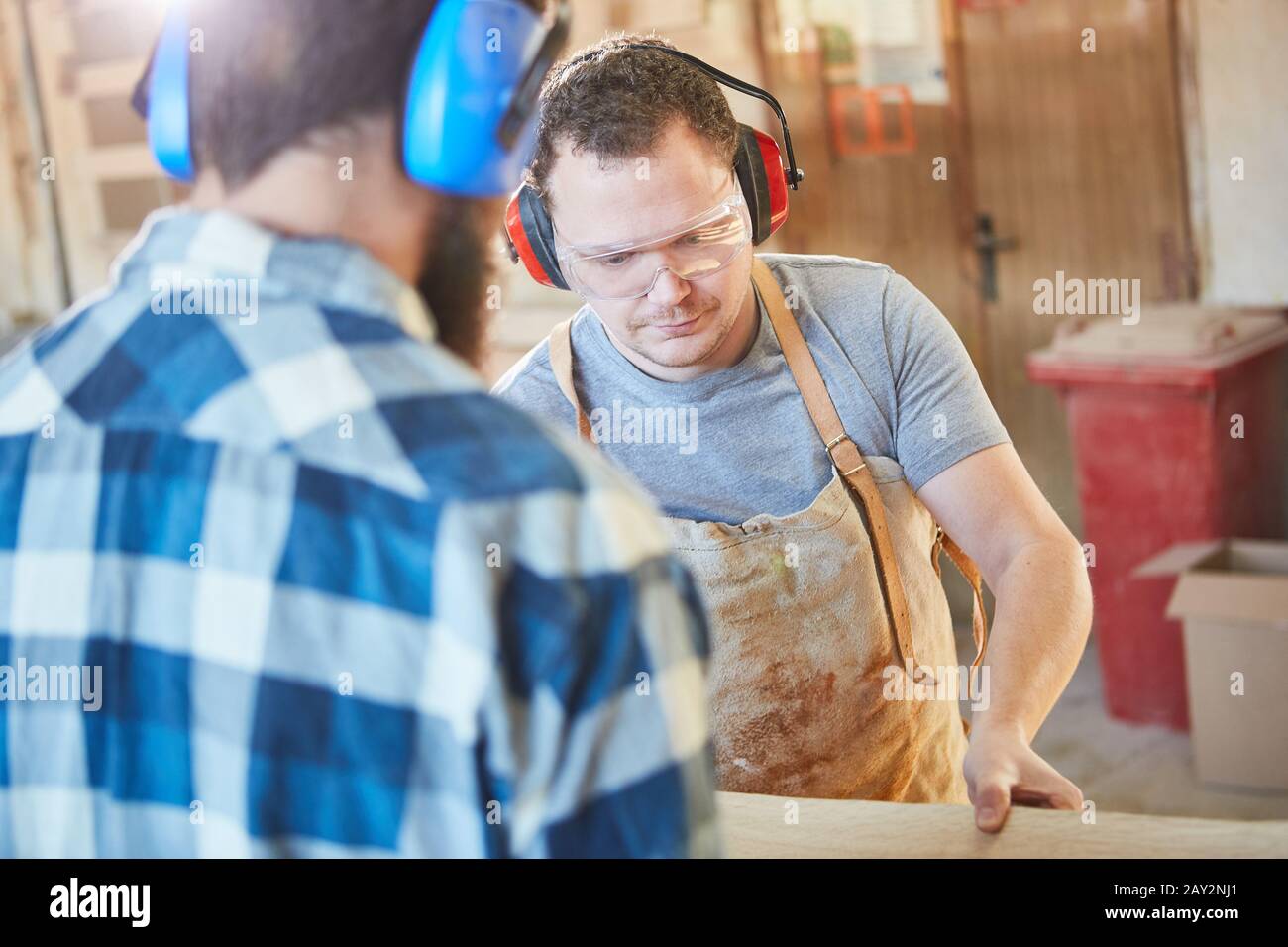 Two carpenters or carpenters work together in the carpentry workshop ...