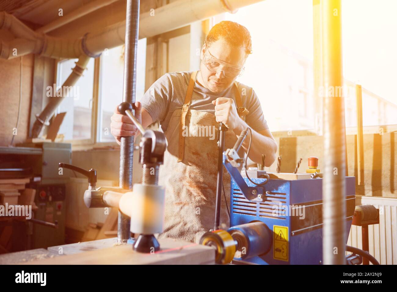 Schreiner uses a modern drill with laser display to drill wood in the ...