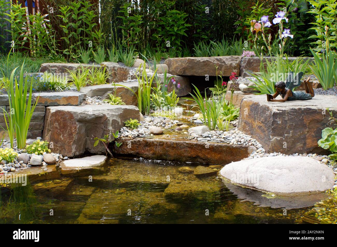 Garden pond with brook run Stock Photo - Alamy