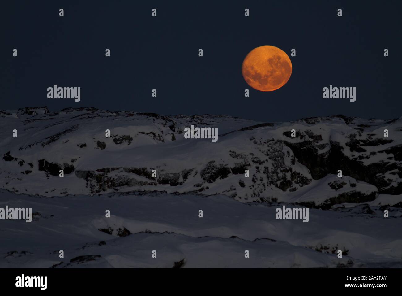 huge moon in the night sky over one of the Antarctic islands Stock ...