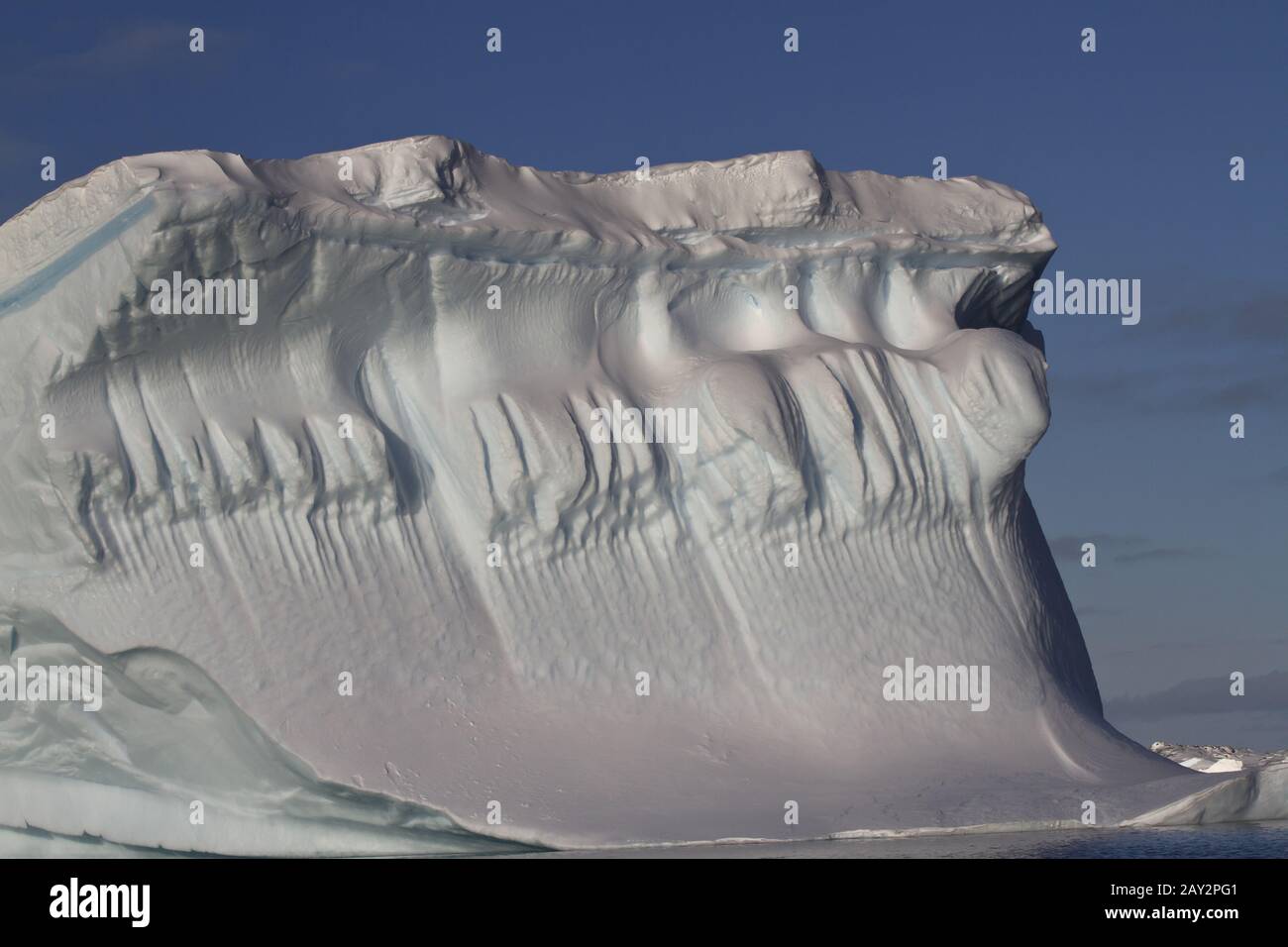 iceberg with a diffuse wall against the blue sky in Antarctica Stock ...