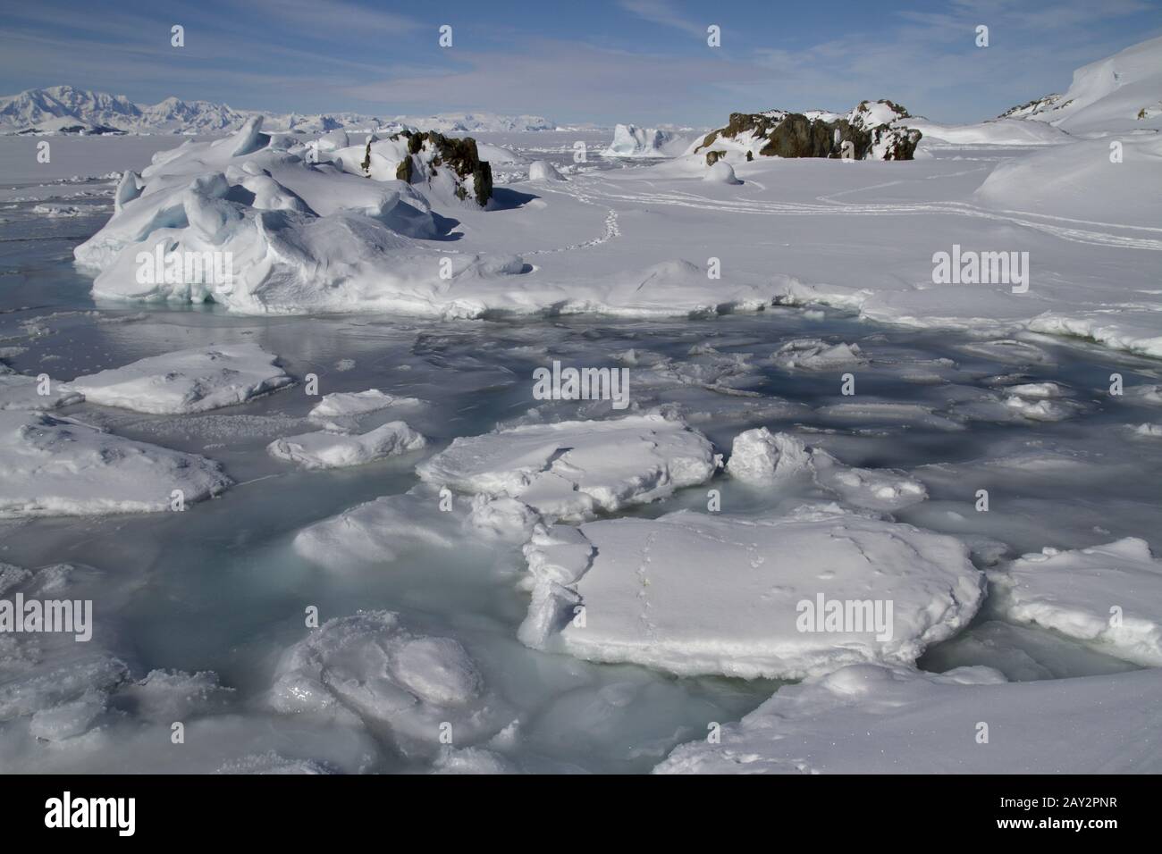 coastal strip of small icebergs and ice islands frozen Antarctic winter ...