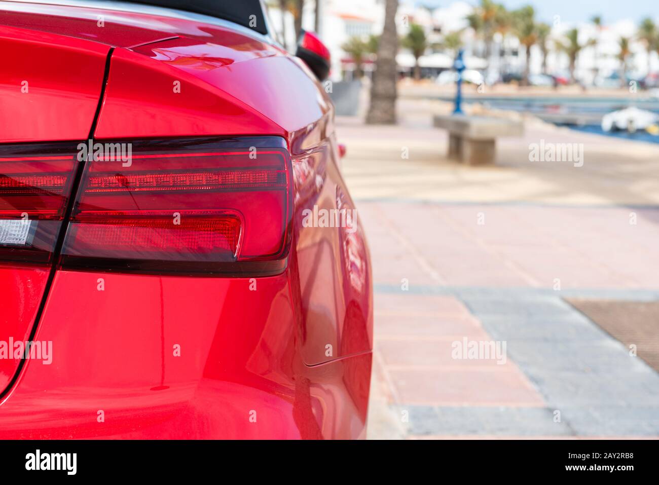 Rear of modern red car with tail lights parked on street Stock Photo ...