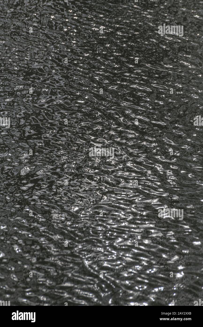 Slightly turbulent water ripples on River Fowey, Lostwithiel, Corrnwall ...