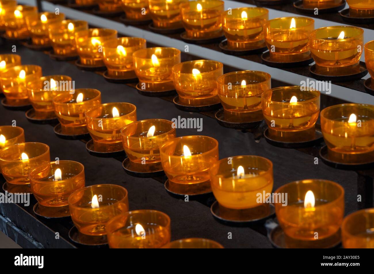 Memorial lights in a church Stock Photo - Alamy