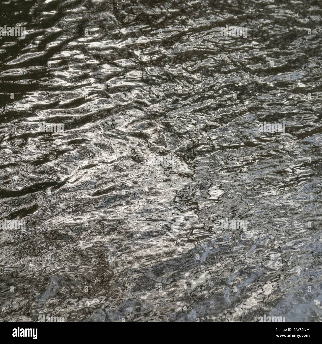Slightly turbulent water ripples on River Fowey, Lostwithiel, Corrnwall ...