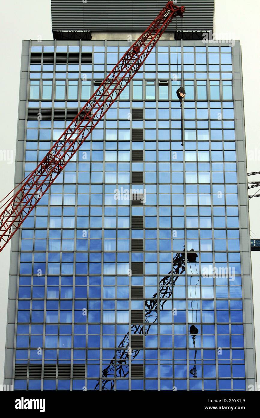 Crane on skyscraper facade Stock Photo - Alamy