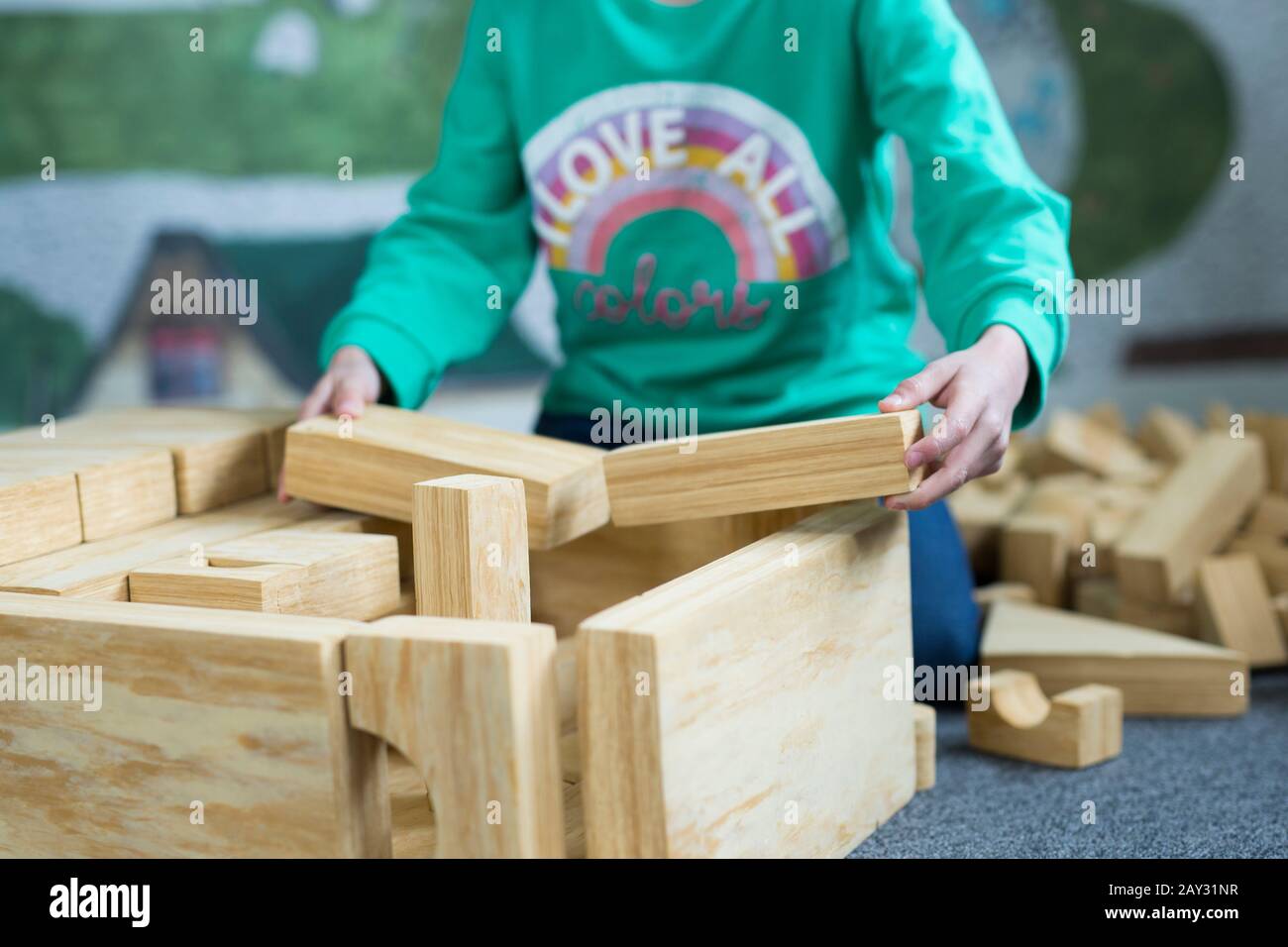 Boy playing with wooden bricks Stock Photo - Alamy