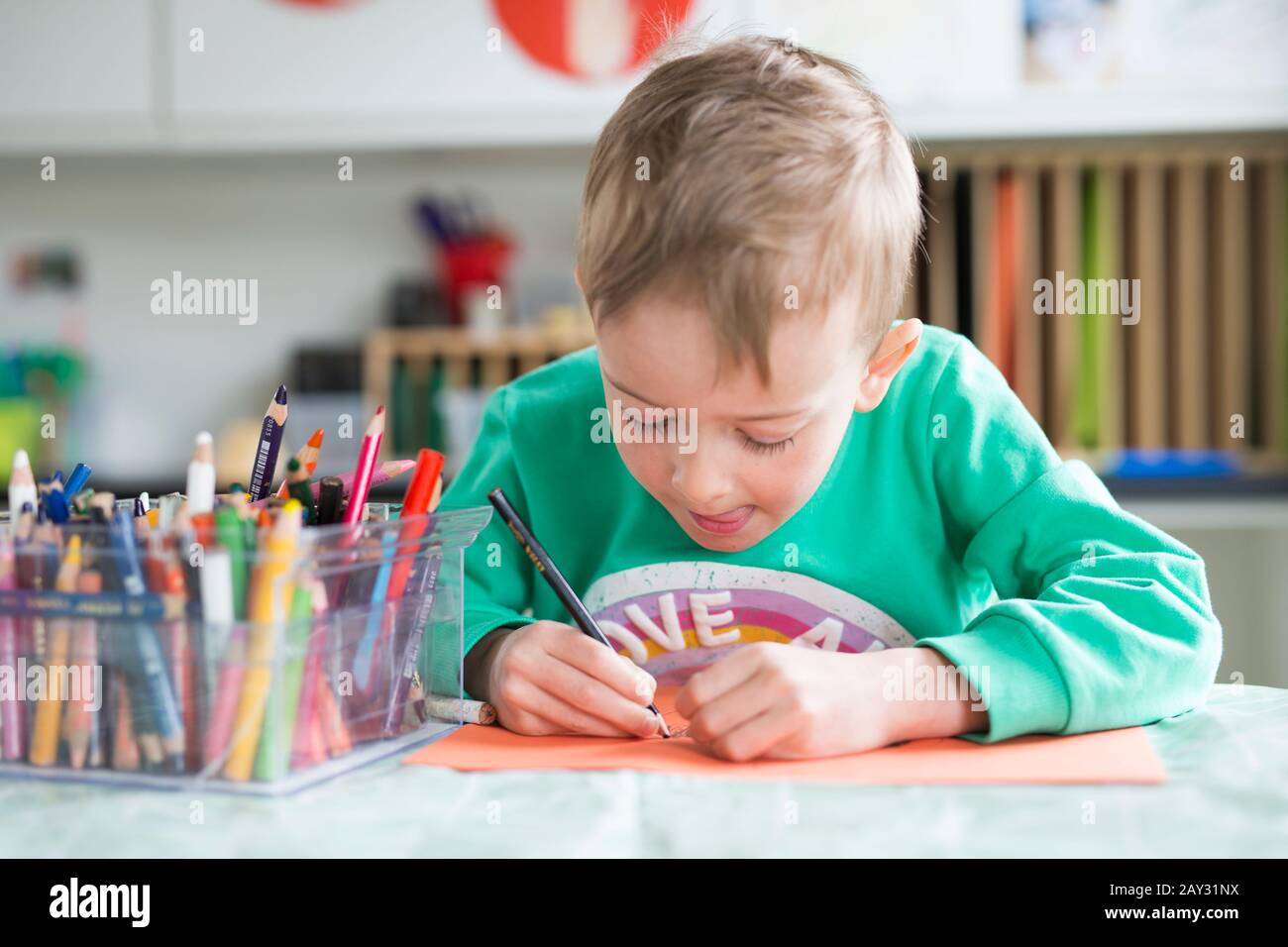 Boy drawing on paper Stock Photo - Alamy