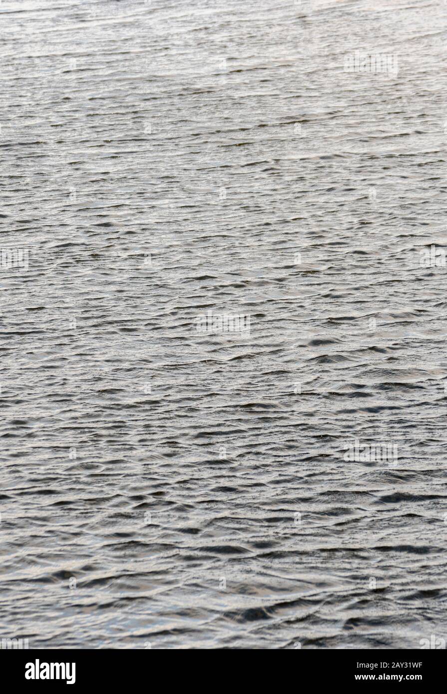 Calm water ripples on the River Fowey at Lostwithiel in Corrnwall ...