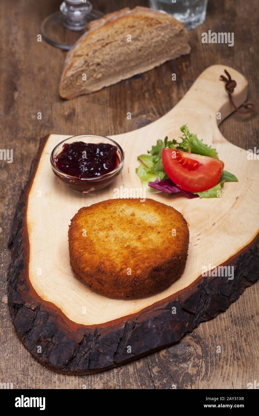 Baked camembert on a wooden board Stock Photo - Alamy