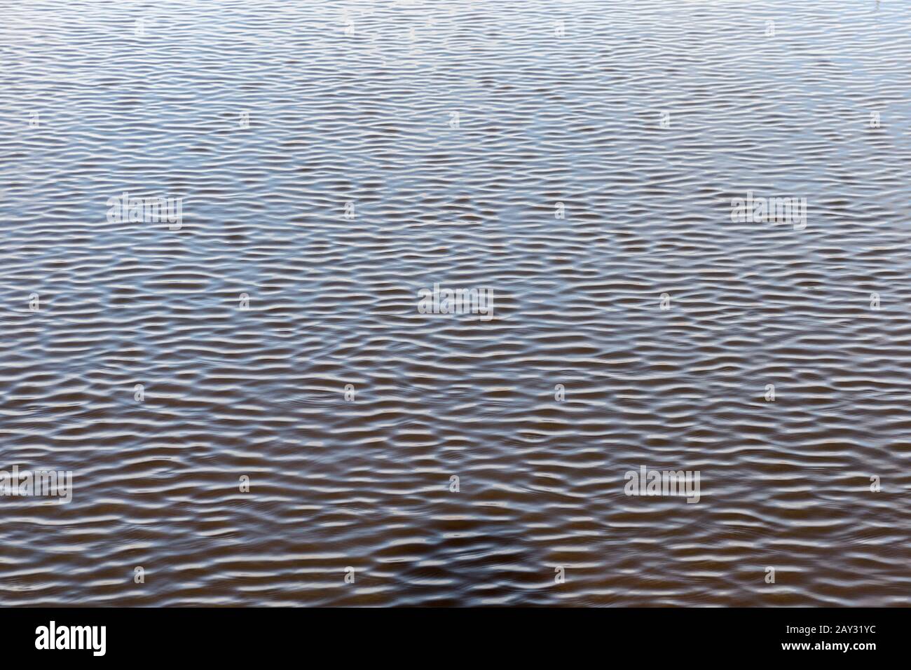 Calm water ripples on the River Fowey at Lostwithiel in Corrnwall ...