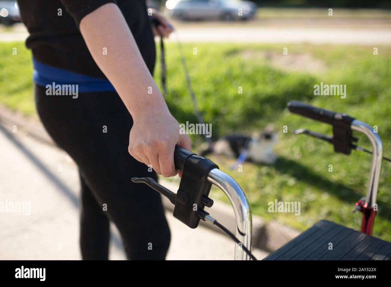 Womans hand holding walking frame handle Stock Photo - Alamy