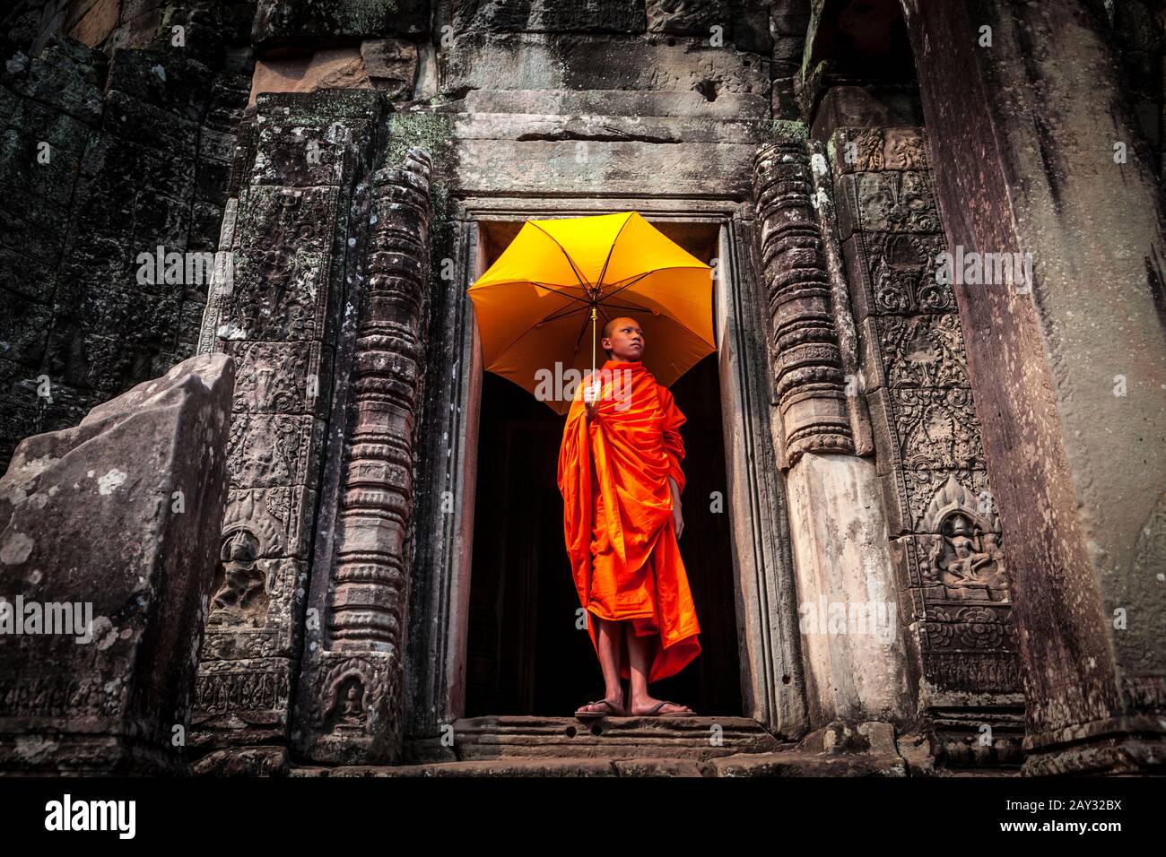 Novice monk in ruined building Stock Photo - Alamy