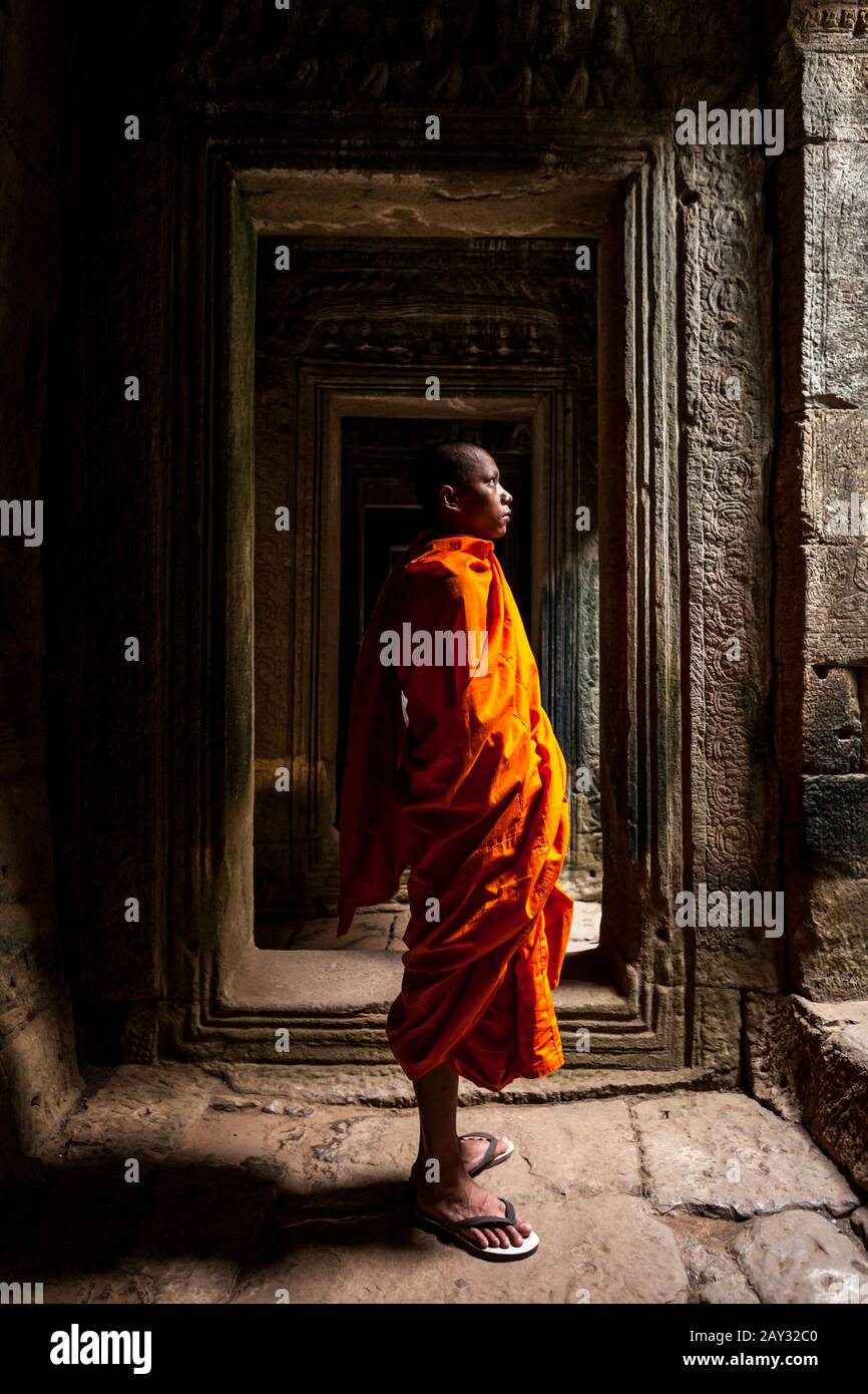 Novice monk in ruined building Stock Photo - Alamy