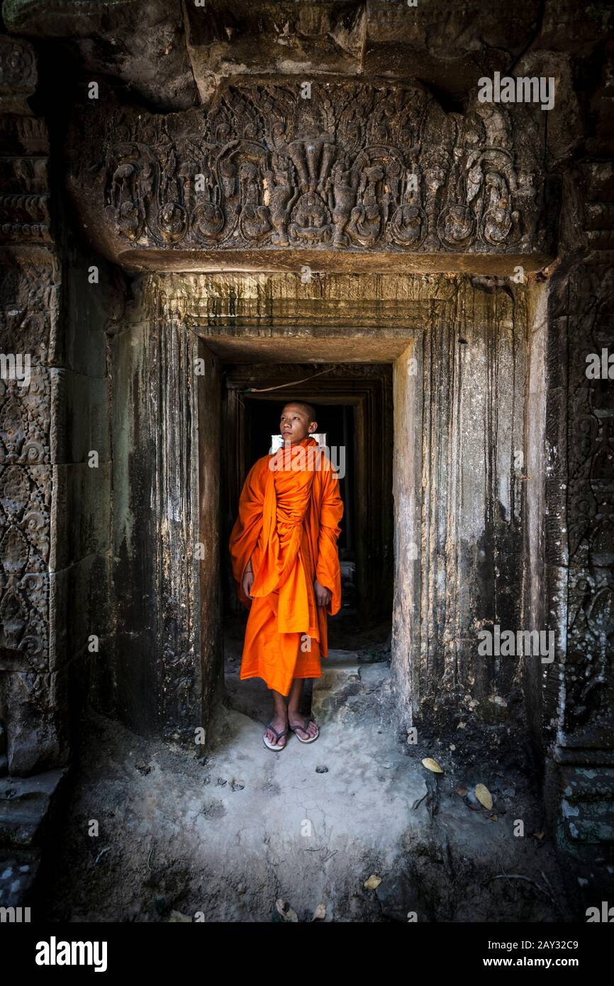 Novice monk in ruined building Stock Photo - Alamy
