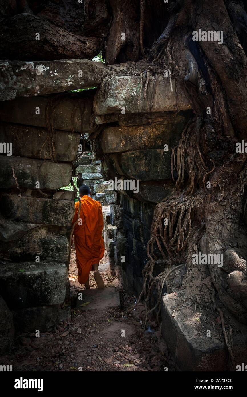 Novice monk in ruined building Stock Photo - Alamy