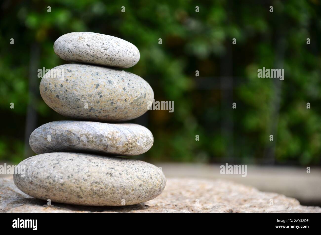 Stack of zen rocks in garden Stock Photo - Alamy