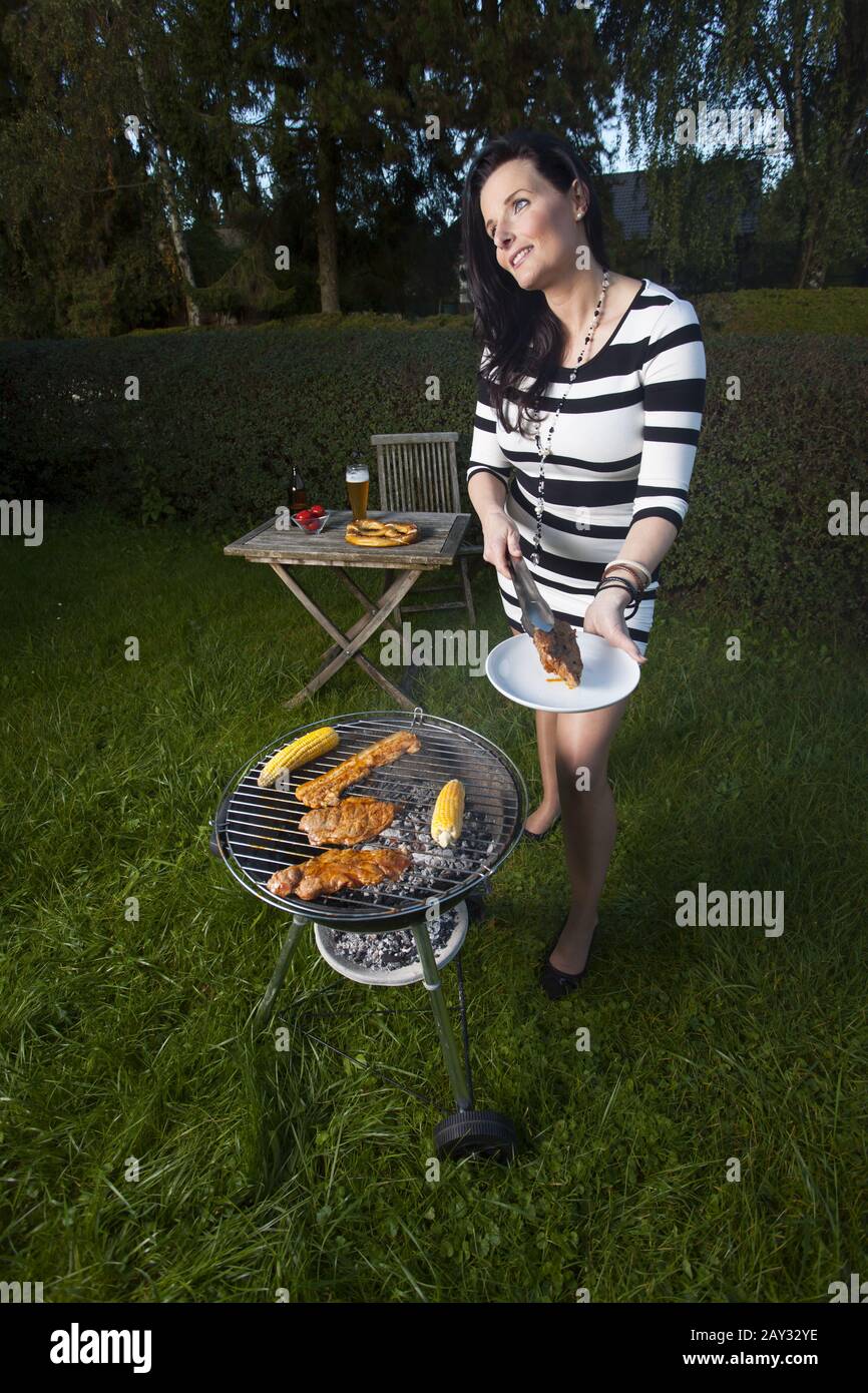 Woman grilling corn hi-res stock photography and images - Alamy