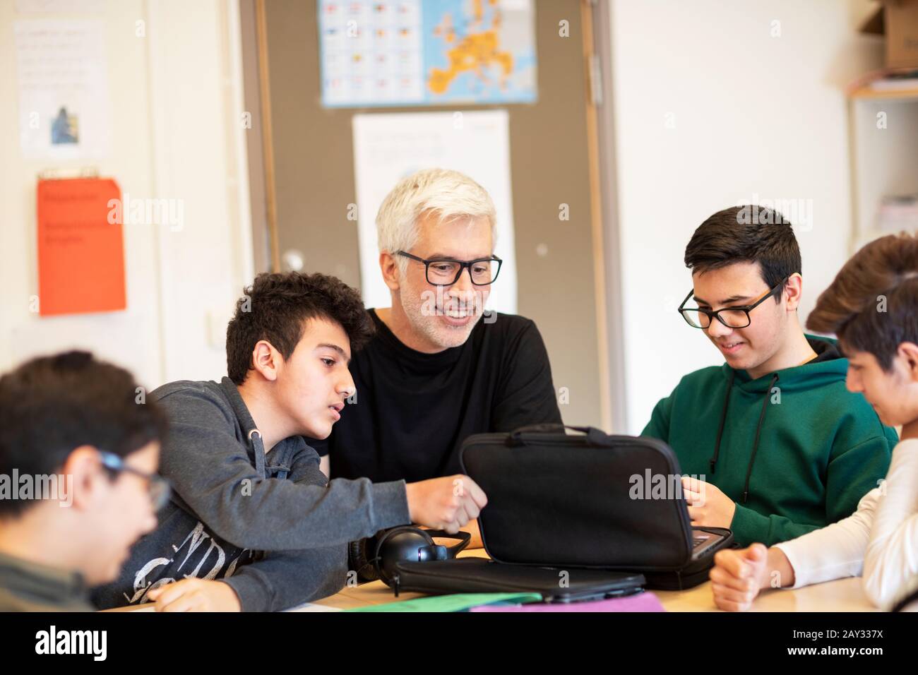 Teacher in classroom talking with students Stock Photo - Alamy