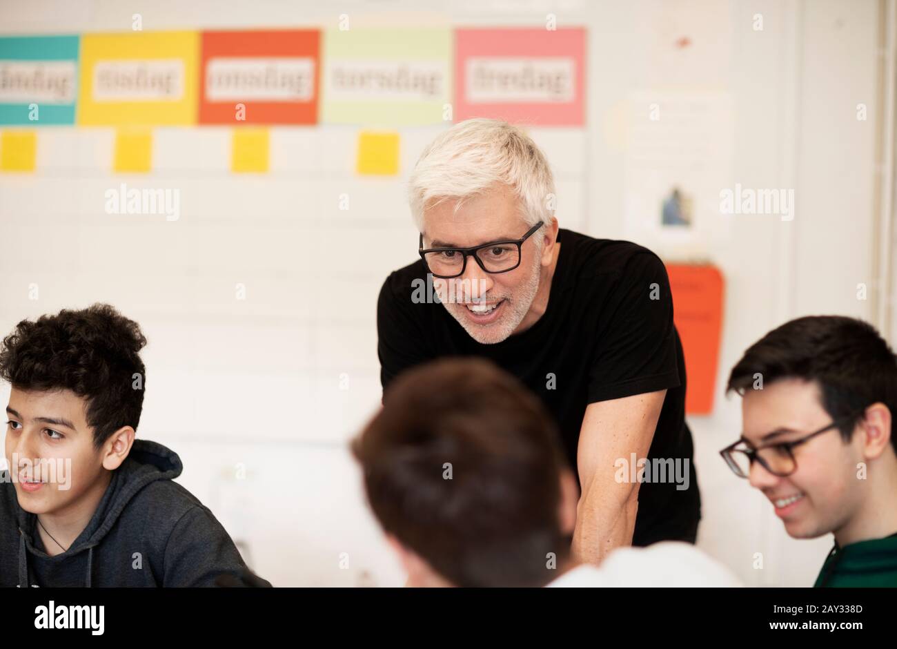 Teacher in classroom talking with students Stock Photo - Alamy