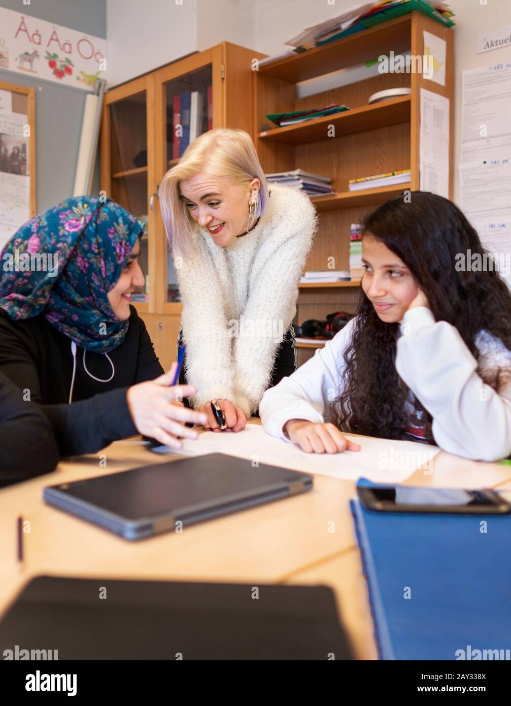 Teacher and students in classroom Stock Photo - Alamy