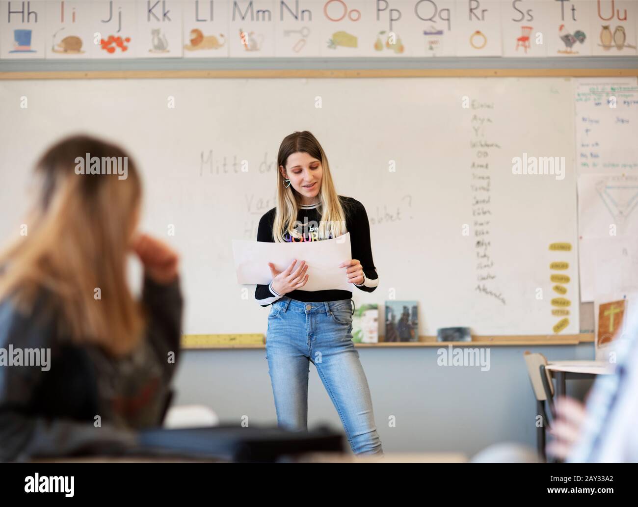 Girl having presentation in classroom Stock Photo - Alamy