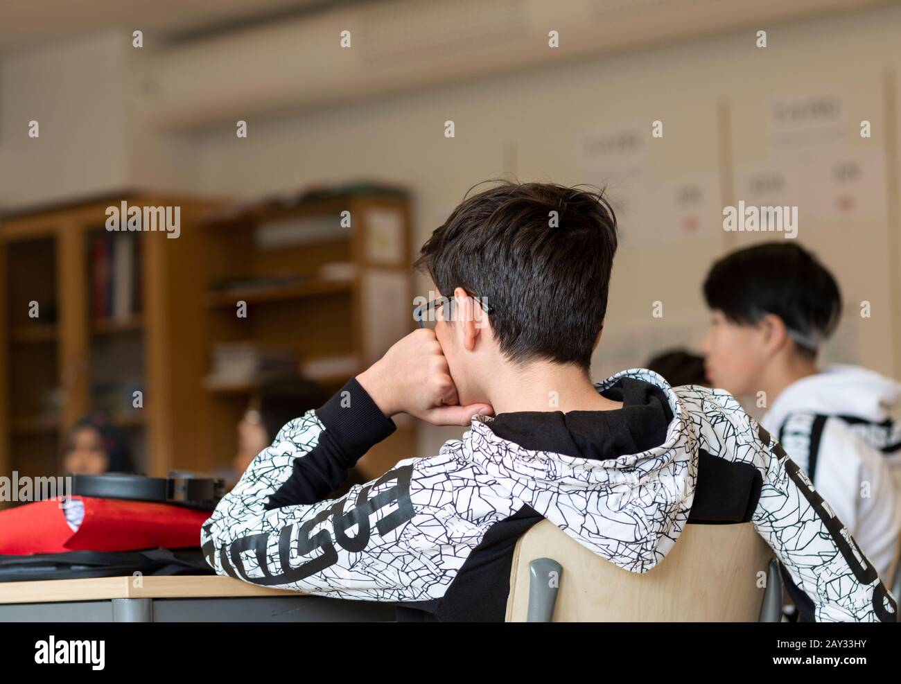 Teenage boy in classroom Stock Photo - Alamy