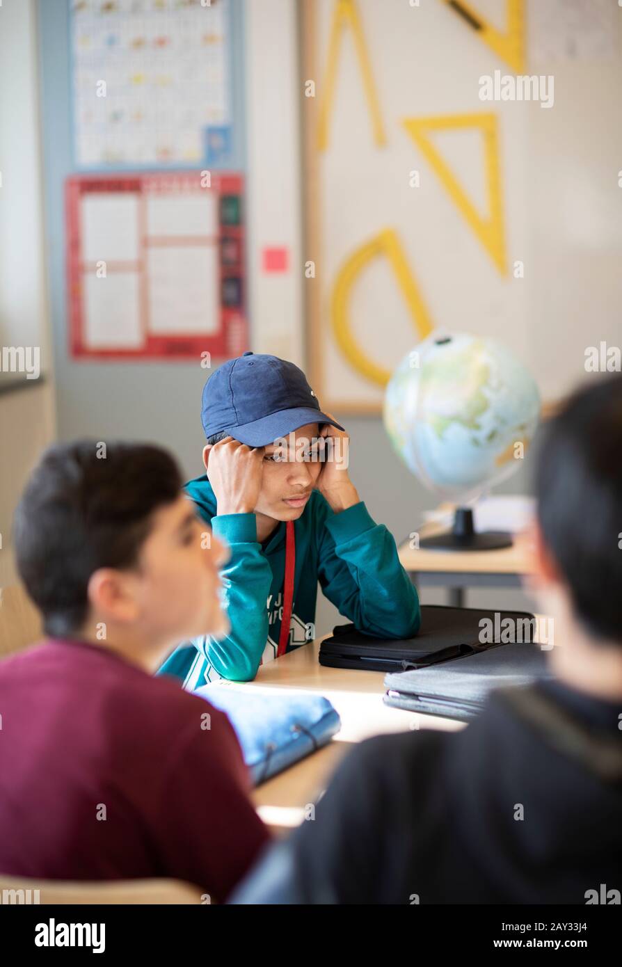 Teenage boy in classroom Stock Photo - Alamy
