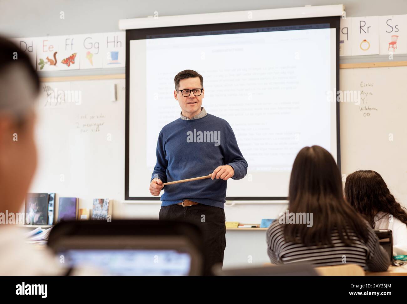 Teacher in classroom Stock Photo - Alamy
