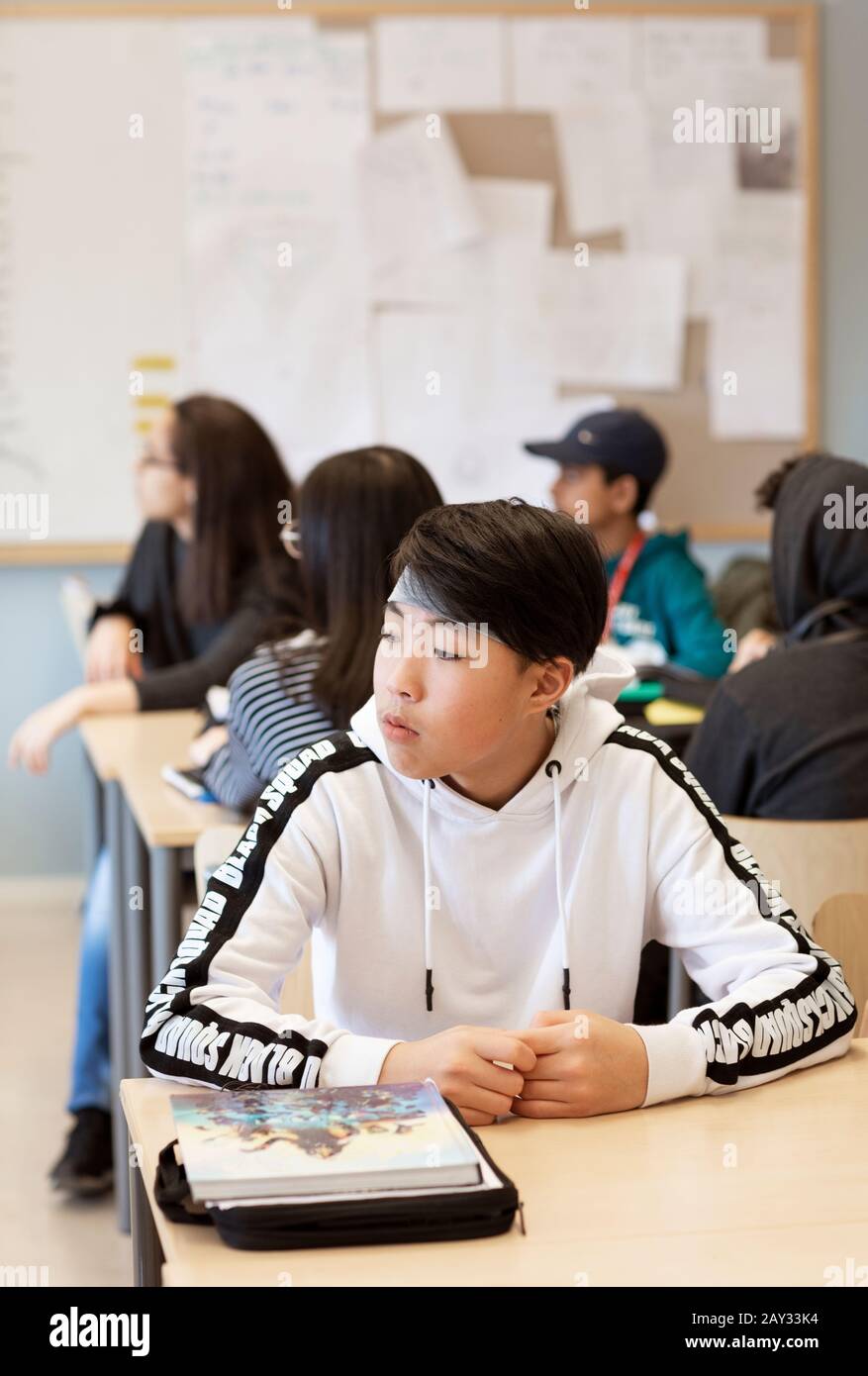 Teenage boy in classroom Stock Photo - Alamy