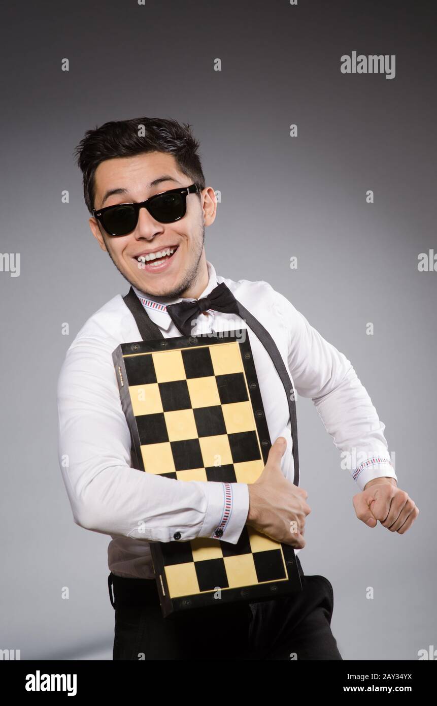 Funny chess player with board Stock Photo - Alamy